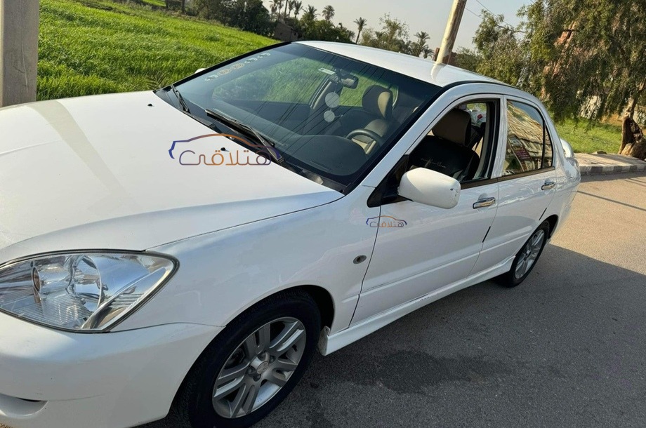 Lancer Puma Mitsubishi 2010 Faiyum White 6517503 - Car for sale : Hatla2ee