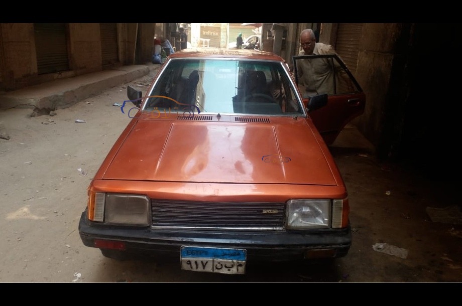 323 Mazda 1984 El Marg Orange 6701414 - Car for sale : Hatla2ee