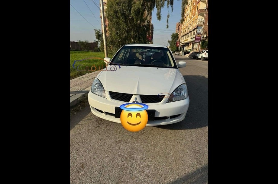 Lancer Puma Mitsubishi 2010 Faiyum White 6733765 - Car for sale : Hatla2ee