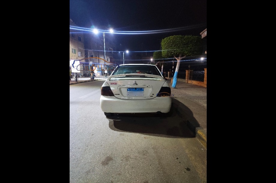 Lancer Puma Mitsubishi 2006 Quesna White 6900853 - Car for sale : Hatla2ee