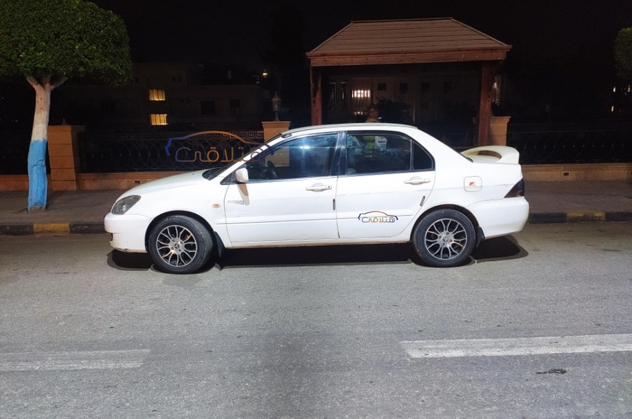 Lancer Puma Mitsubishi 2006 Quesna White 6900853 - Car for sale : Hatla2ee