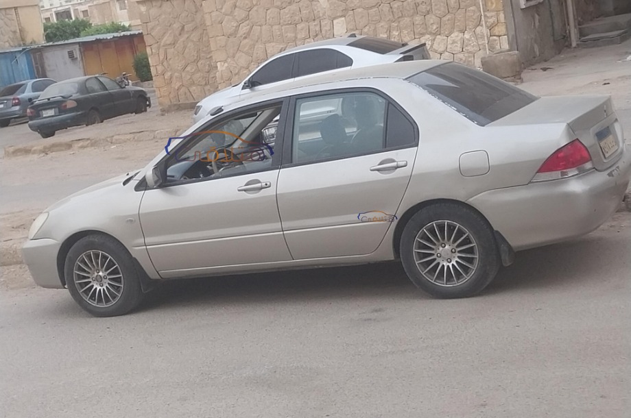 Lancer Puma Mitsubishi 2004 Suez Silver 6944341 - Car for sale : Hatla2ee